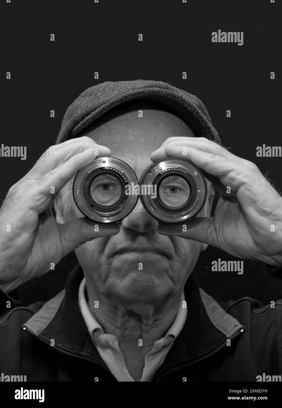 Man looking through two lenses, symbol image, espionage, seeing Stock ...