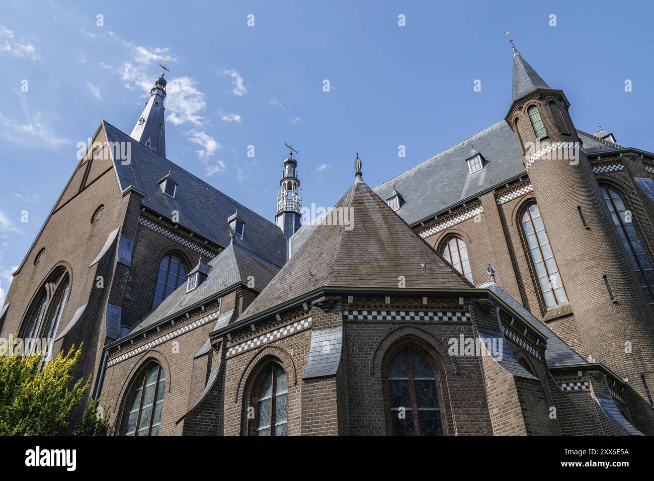 Large brick church with impressive towers and blue sky, Borculo ...