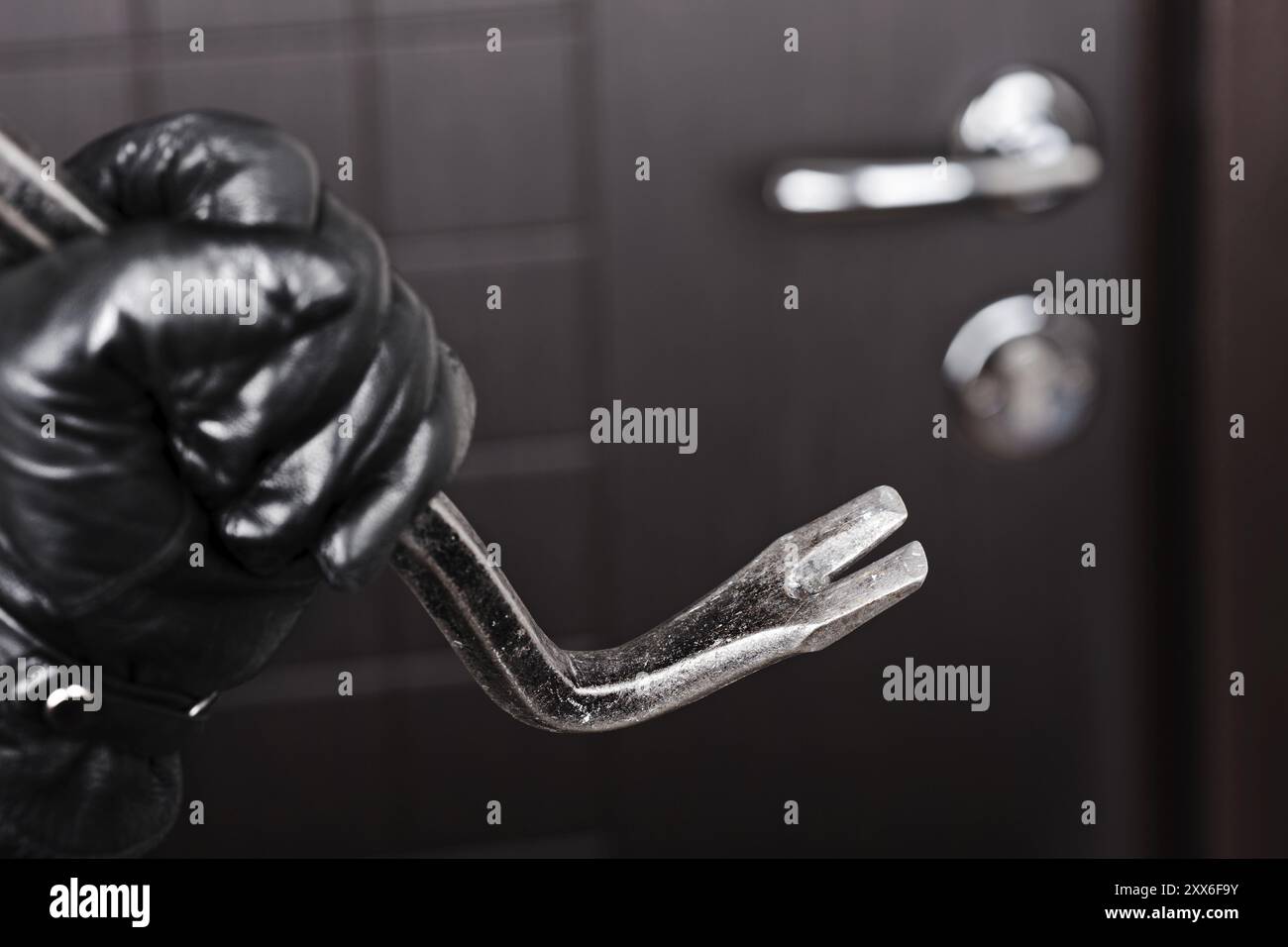 Crime scene, criminal thief or burglar hand in gloves holding metal ...