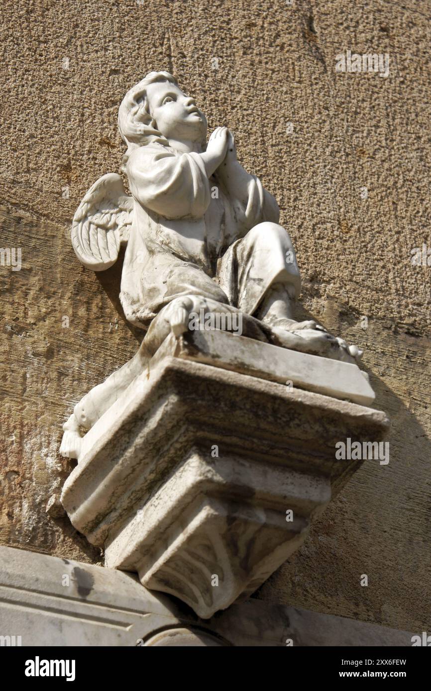 Marble angel prayer statue in an old catholic cemetery Stock Photo - Alamy