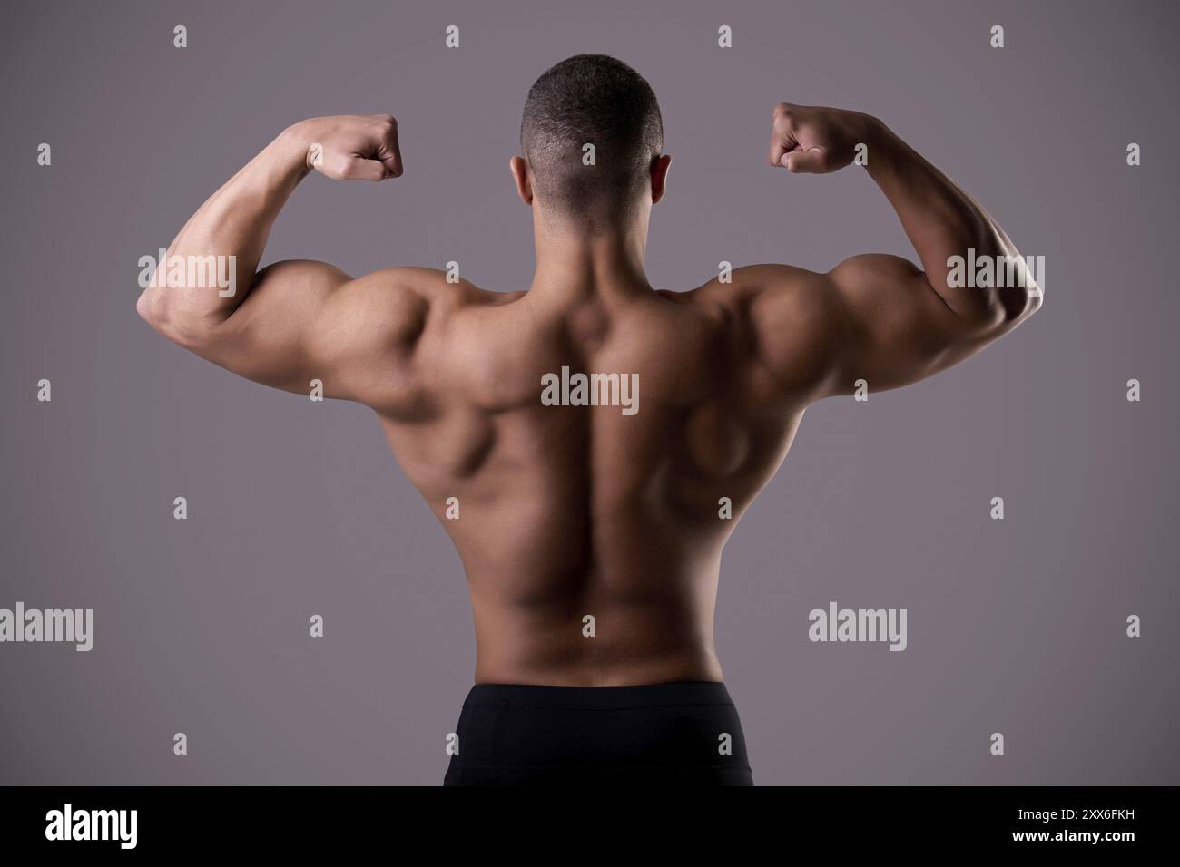 Bodybuilder doing a Back Double Biceps pose Stock Photo - Alamy