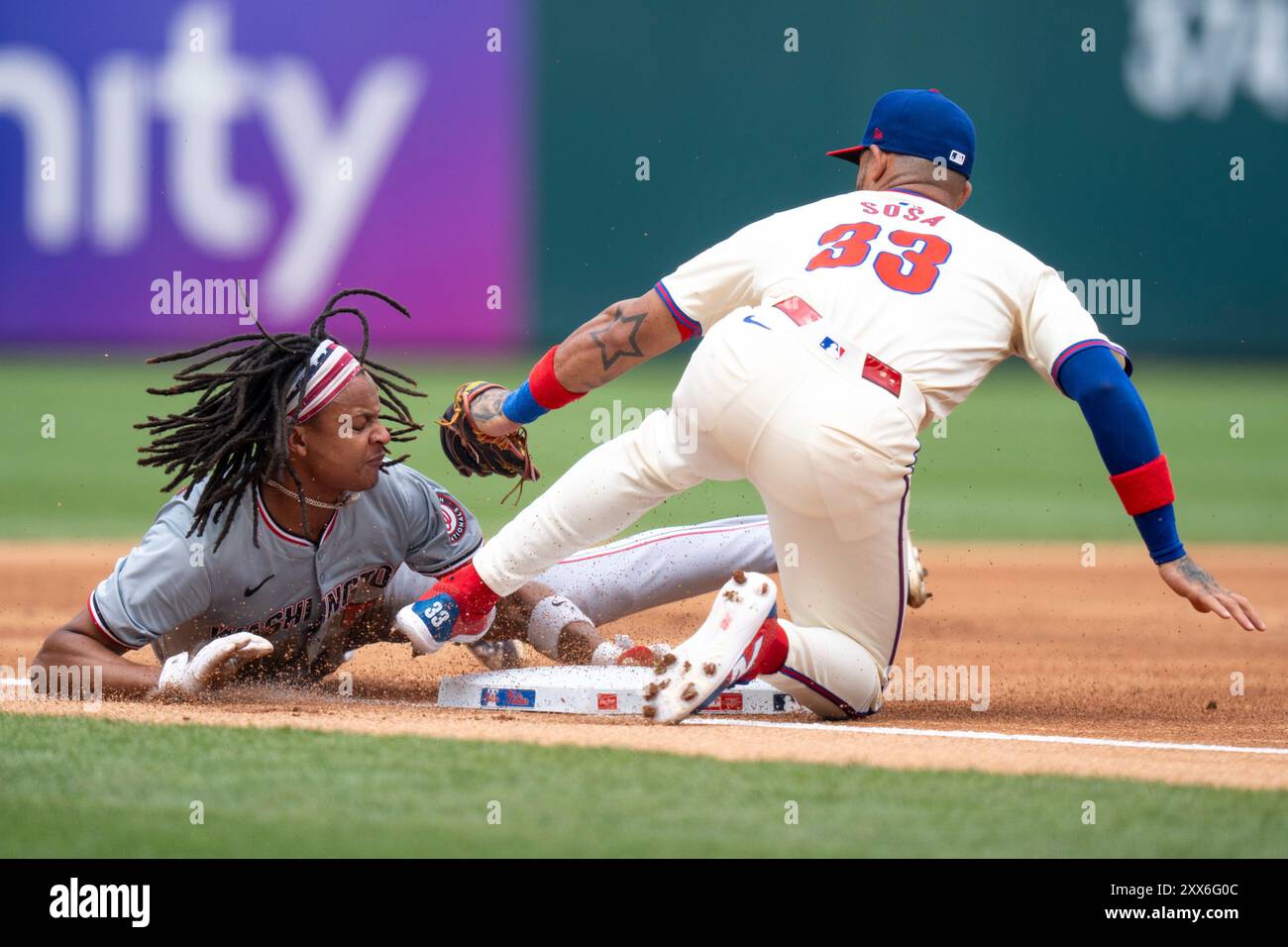 Philadelphia Phillies third baseman Edmundo Sosa, right gets the ball ...