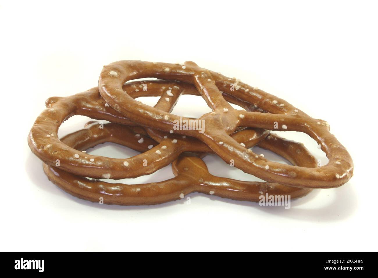 Three salted pretzels against a white background Stock Photo - Alamy