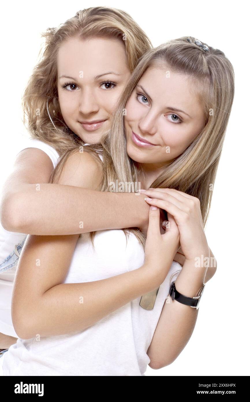 Two beautiful women in a white T-shirts on a white background isolated ...