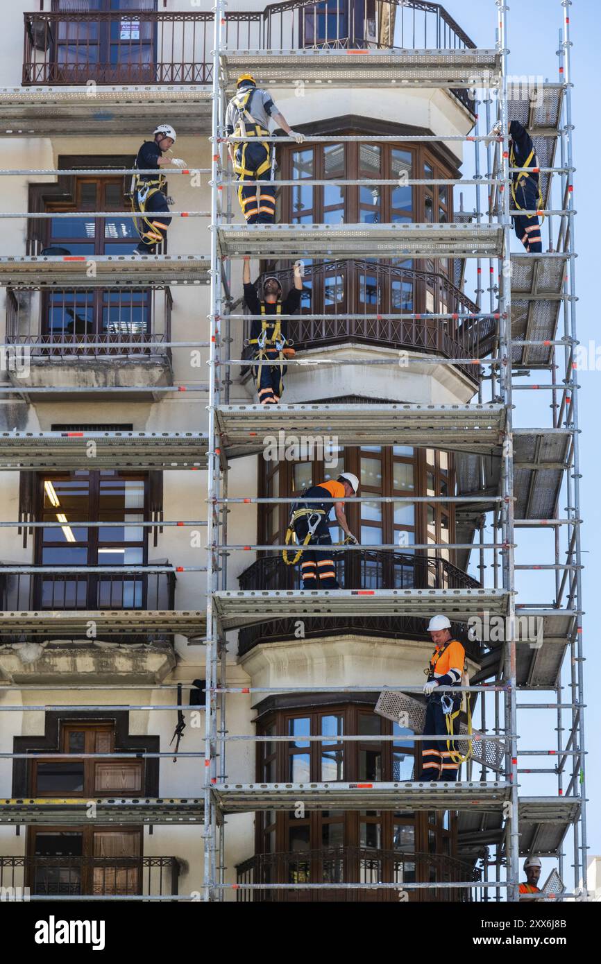 Several construction workers on scaffolding at a house in Tarragona ...
