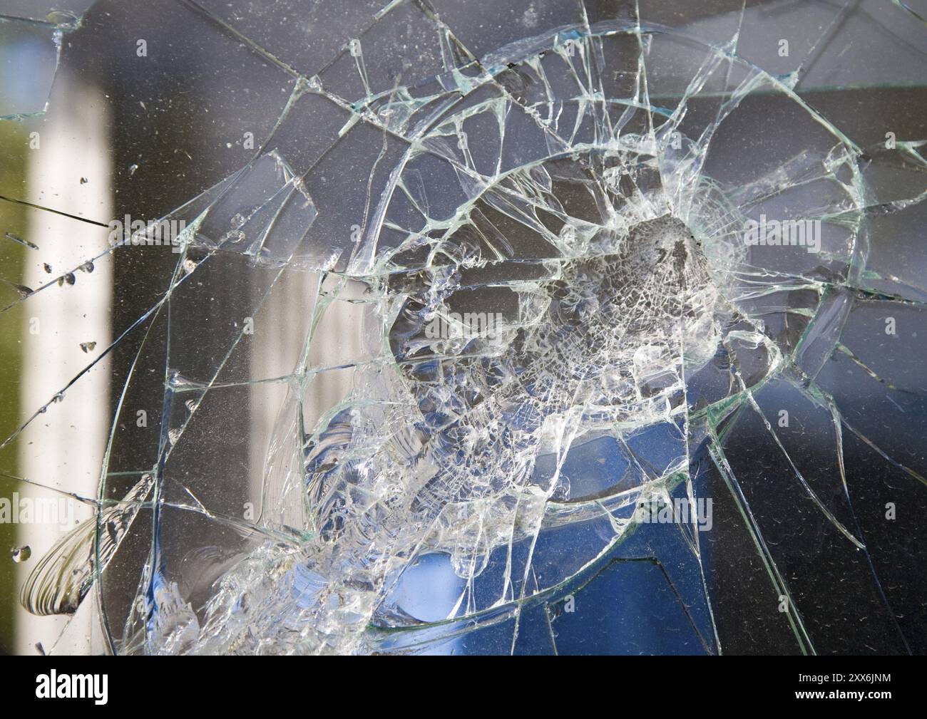 Grey window broken by vandals Stock Photo - Alamy