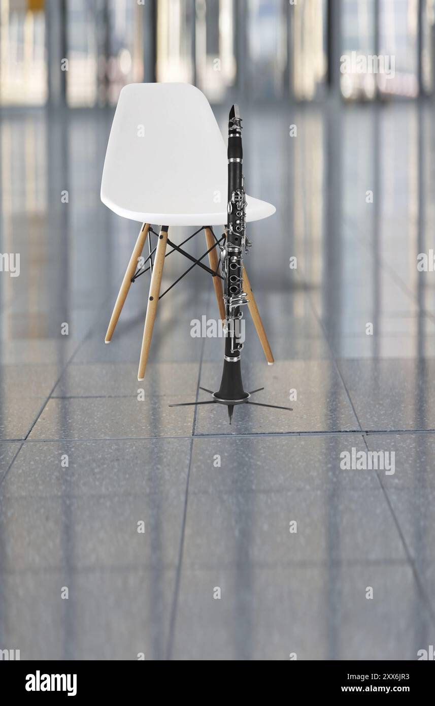 Clarinet and a white chair in an auditorium Stock Photo - Alamy