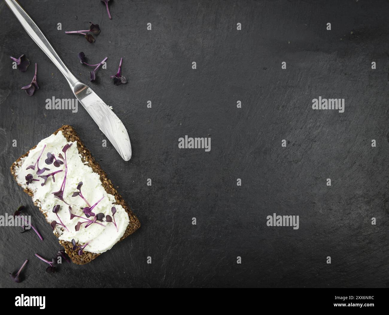 Slate slab with cream cheese and fresh cress on a slice of wholemeal ...
