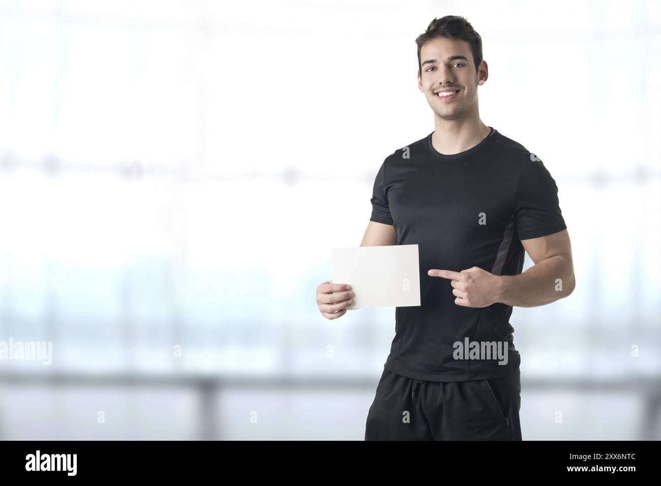 Male Personal Trainer Holding an Empty Card Stock Photo - Alamy