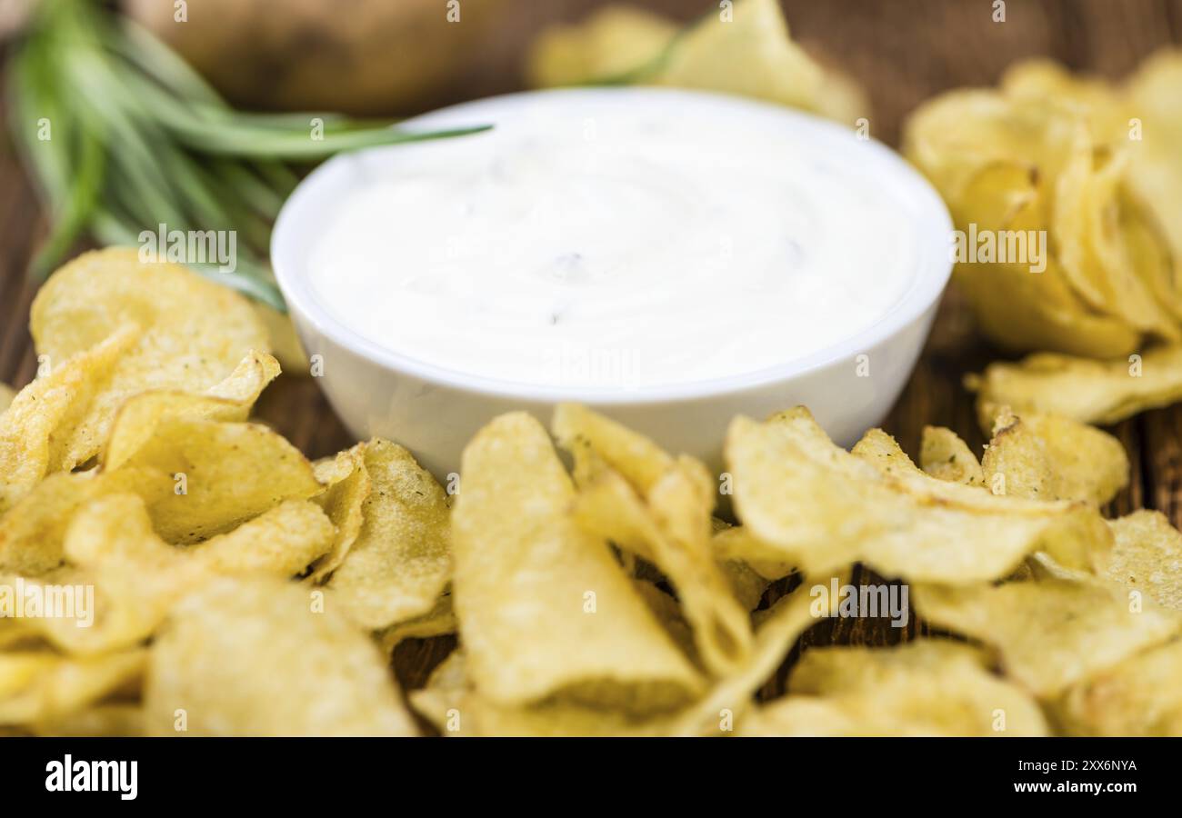 Fresh made Potato Chips with Sour Cream taste on a vintage background ...