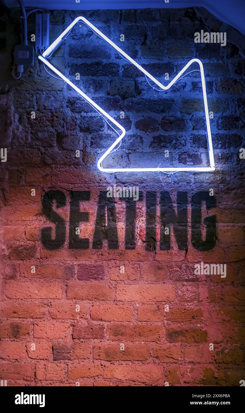 Seating sign with arrow pointing down Stock Photo - Alamy