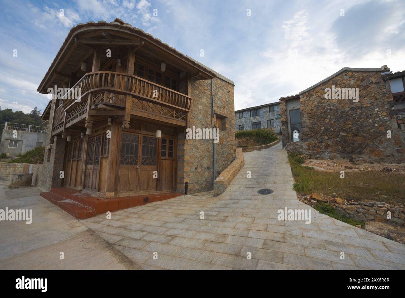A traditional brick house with a typical curved wooden balcony in the ...