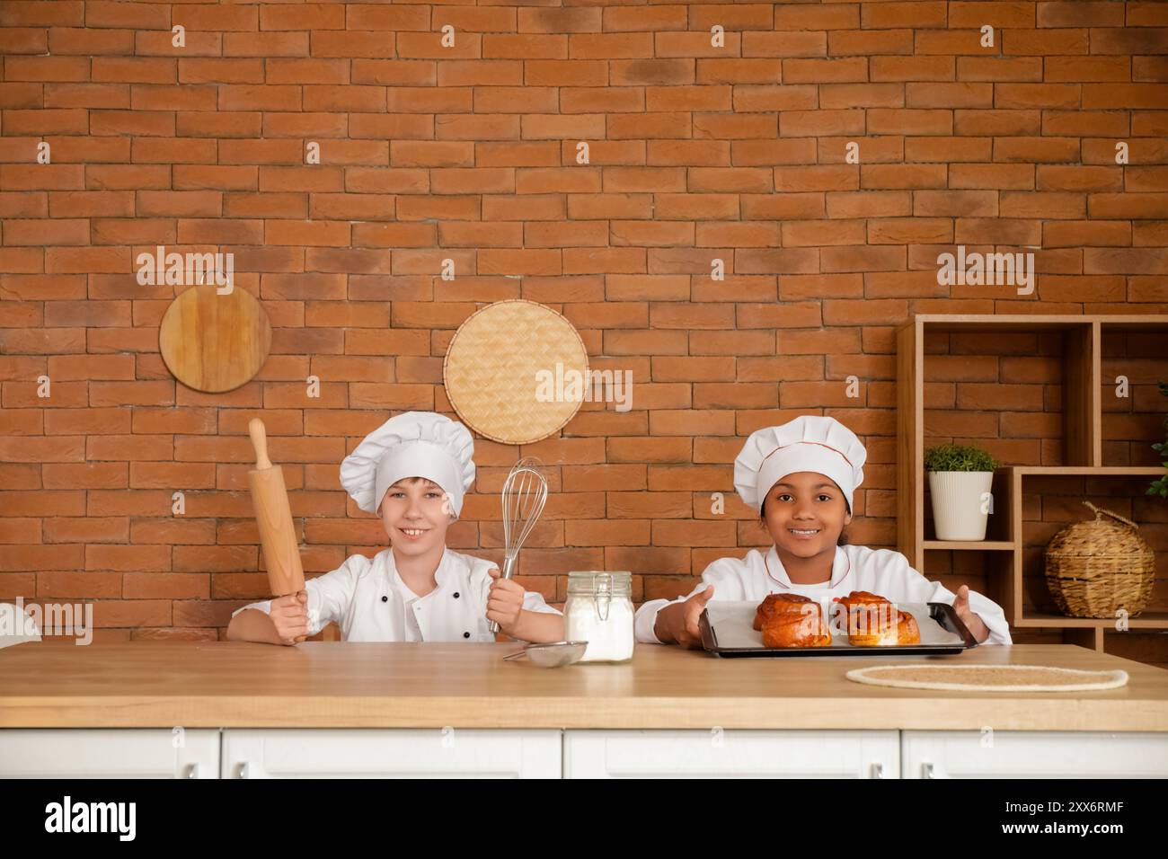 Teenage chefs with utensils and fresh pastry in kitchen Stock Photo - Alamy
