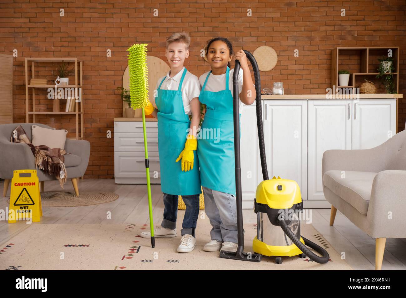 Teenage janitors with mop and vacuum cleaner at home Stock Photo - Alamy