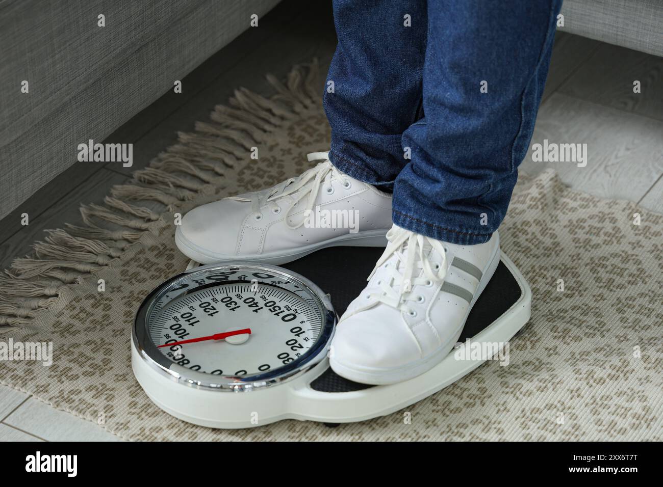 Young overweight man with scales at home. Weight gain concept Stock ...