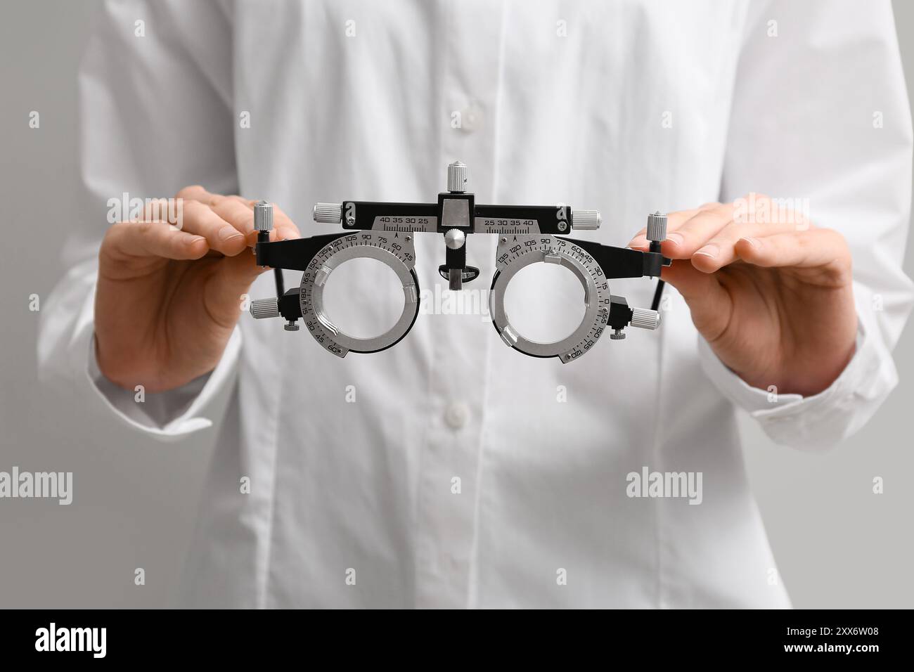 Doctor with optical trial frame on white background Stock Photo - Alamy