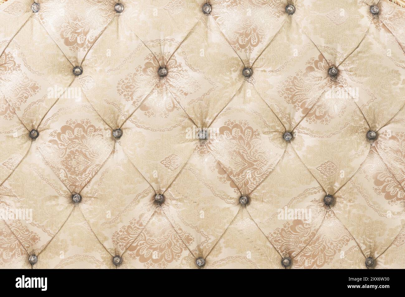 Beige soft tapestry pattern background with symmetrical buttons on the ...