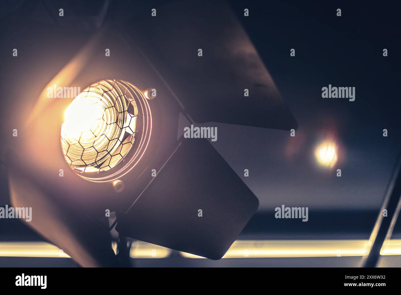 Professional orange studio spotlight hanging on the ceiling Stock Photo ...