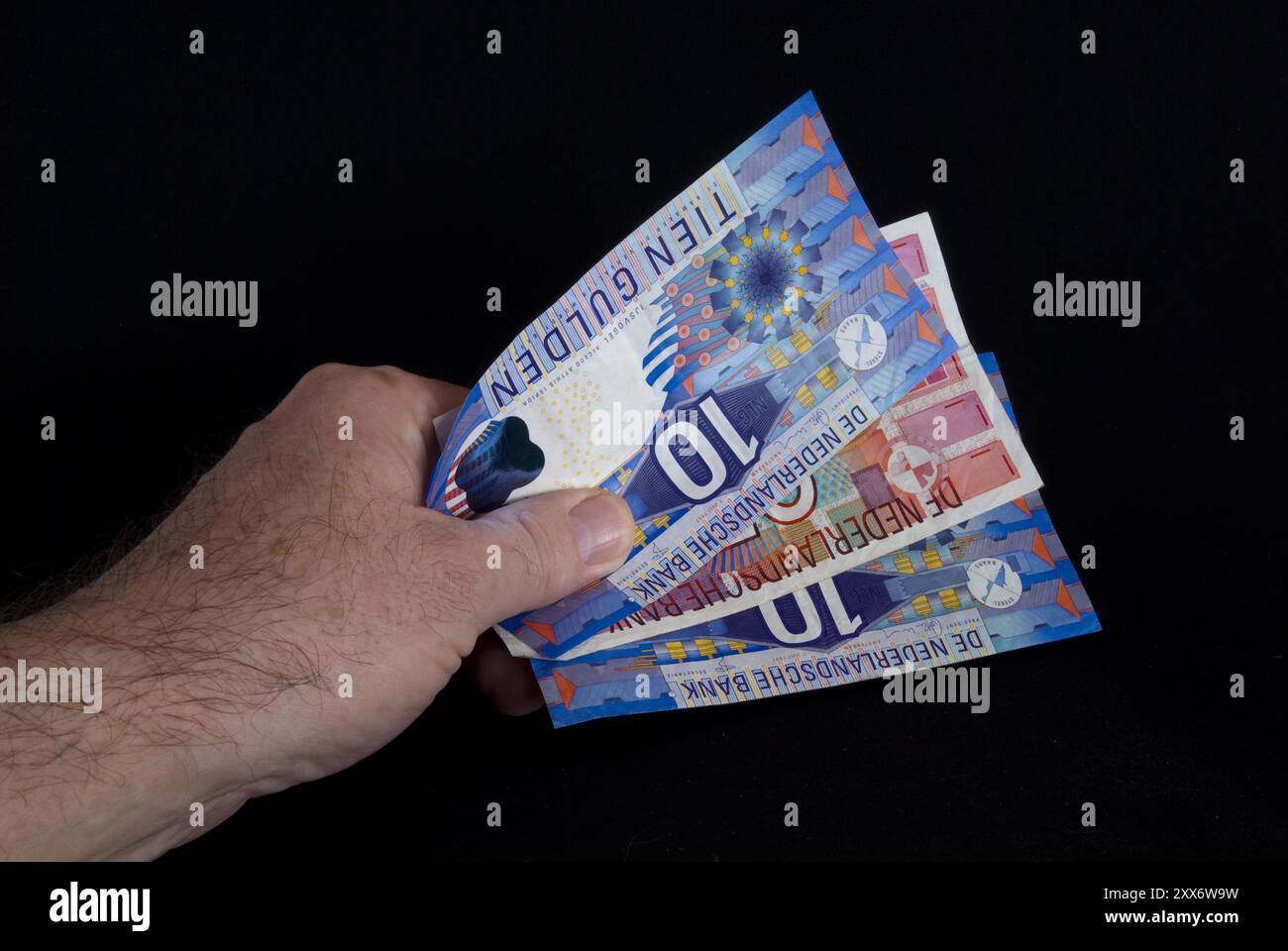 Hand holds old guilders Stock Photo - Alamy