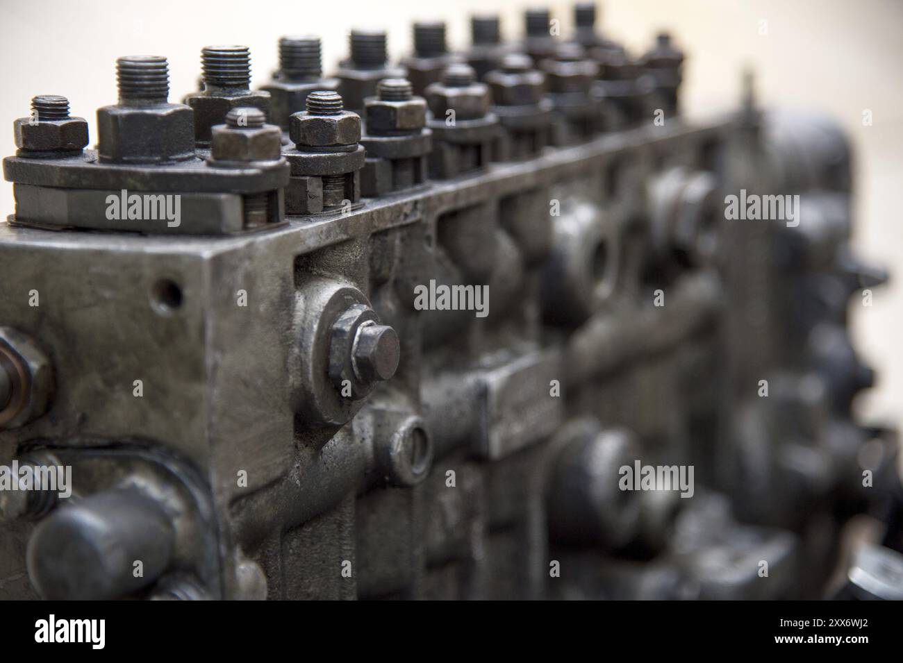 A close-up of an old mechanical high-pressure diesel pump. The shallow ...