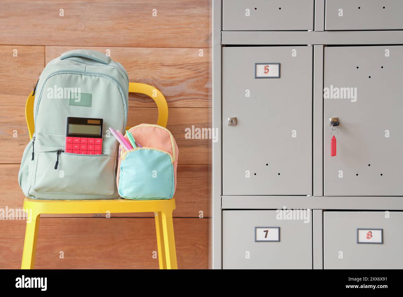 Locker with school backpacks near wooden wall Stock Photo - Alamy