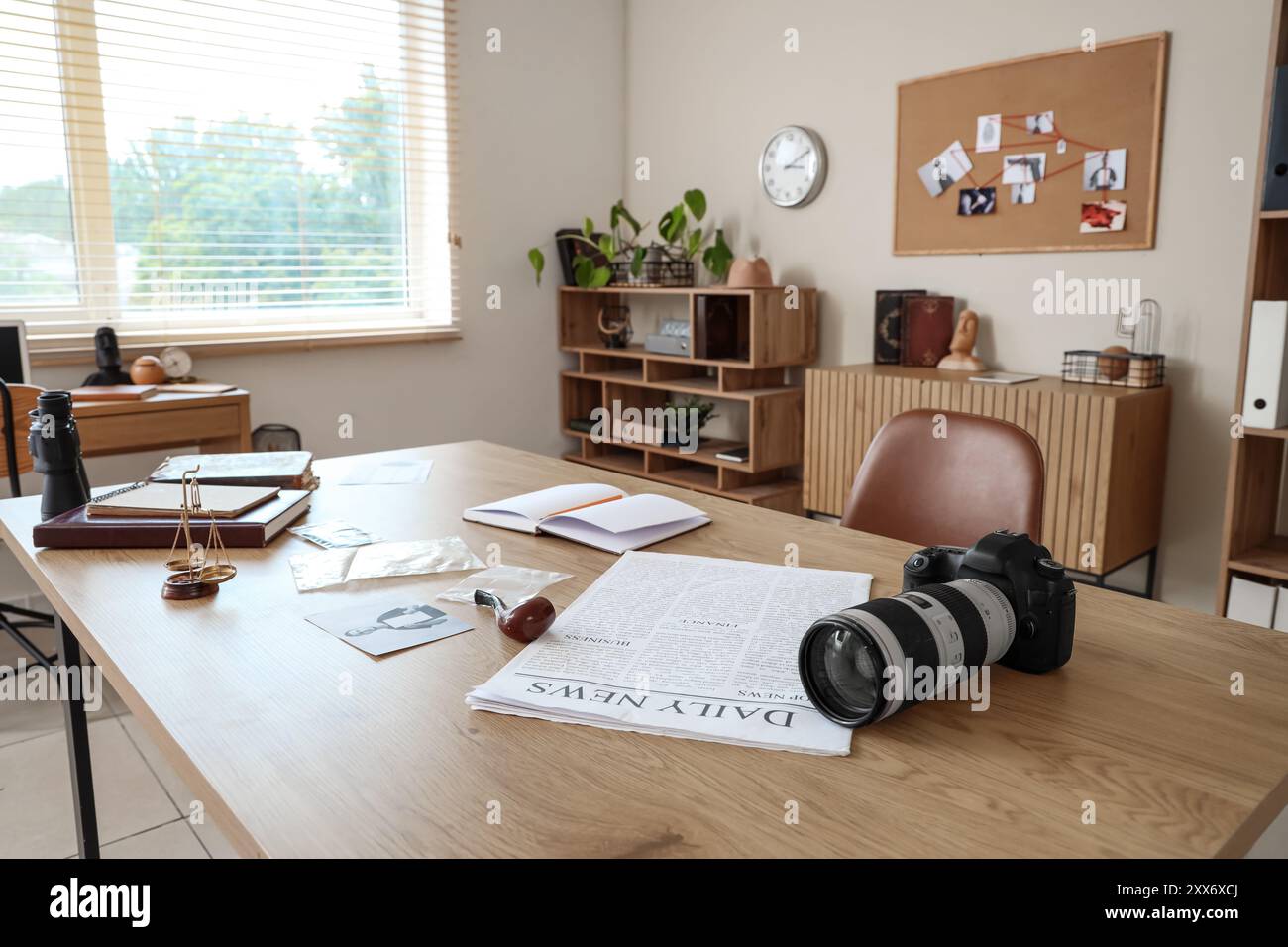 Detective's workplace with photo camera, newspaper and smoking pipe in ...