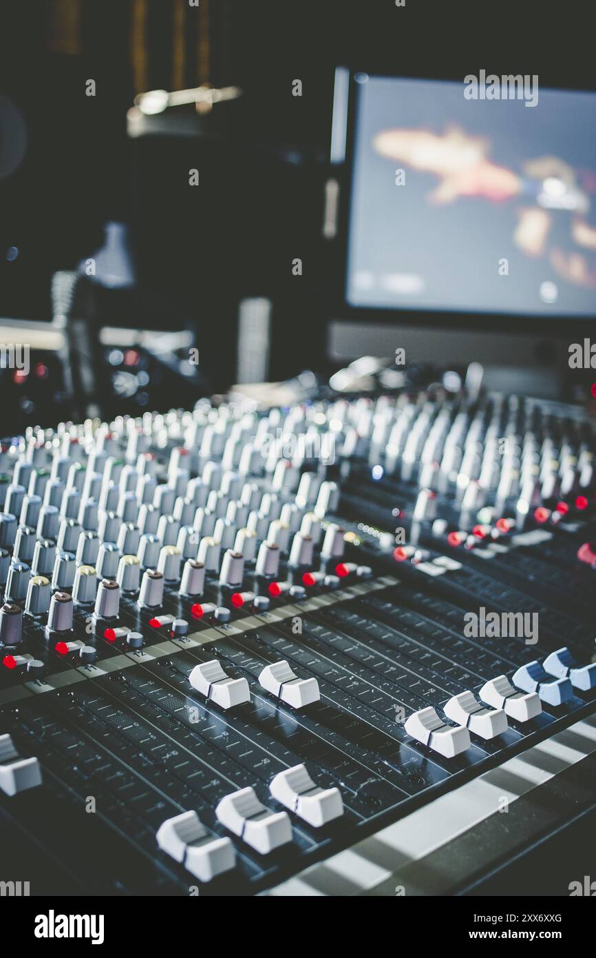 Professional music production in a sound recording studio, mixer desk ...