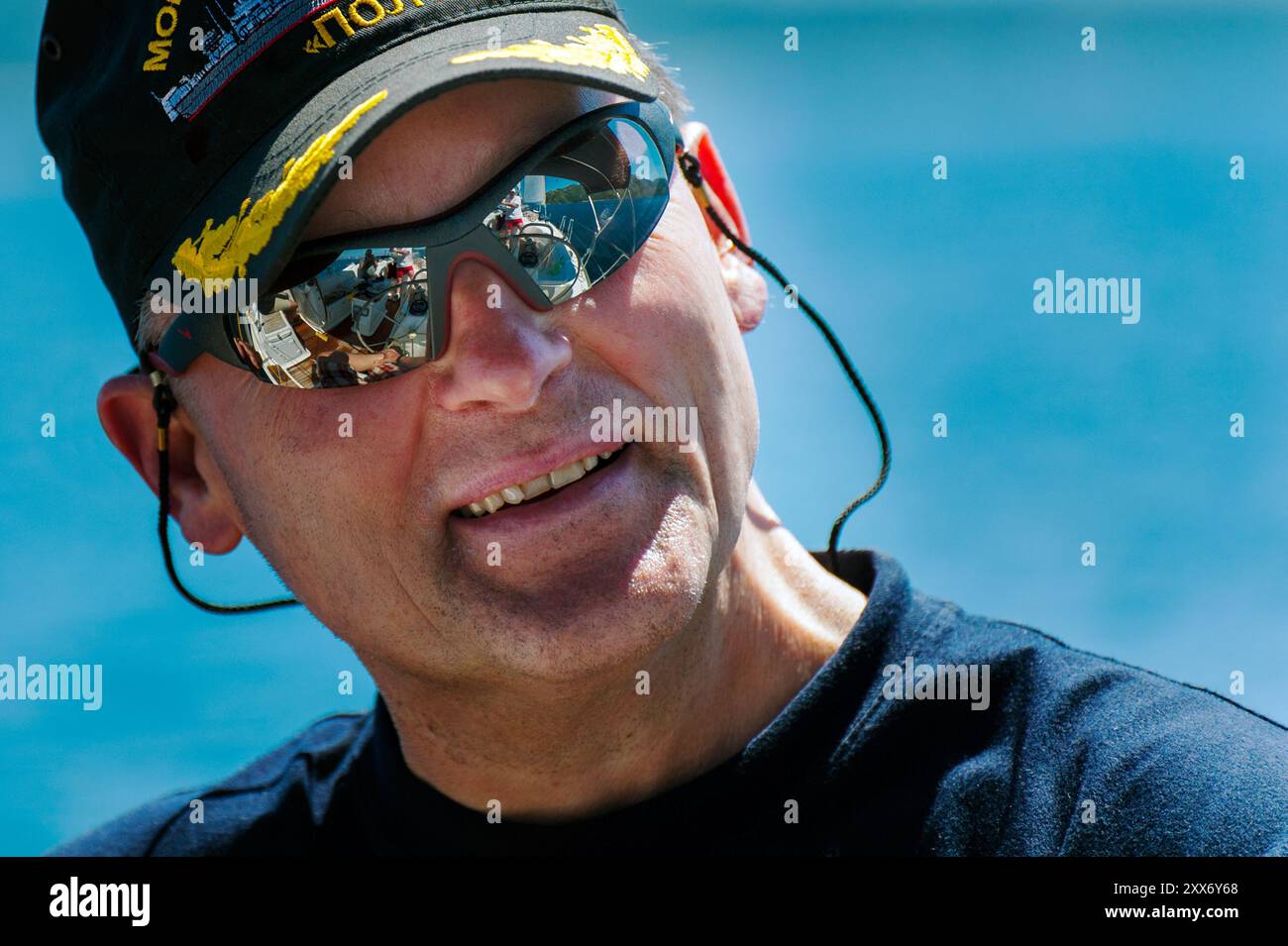 Portrait of a skipper with cap and sunglasses Stock Photo - Alamy