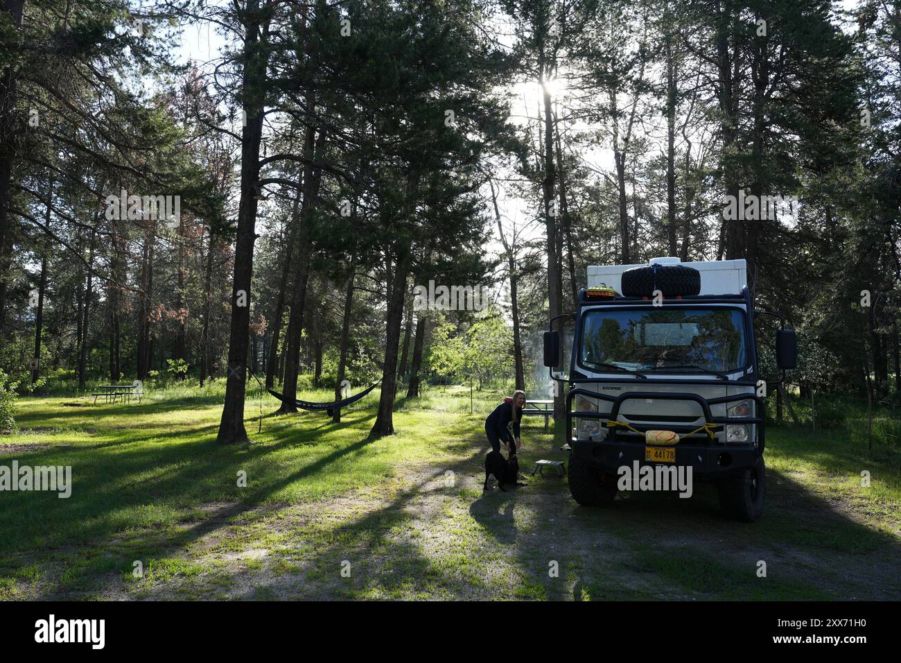 Overland truck in the wooded mountains with sun rays and sunset Stock ...