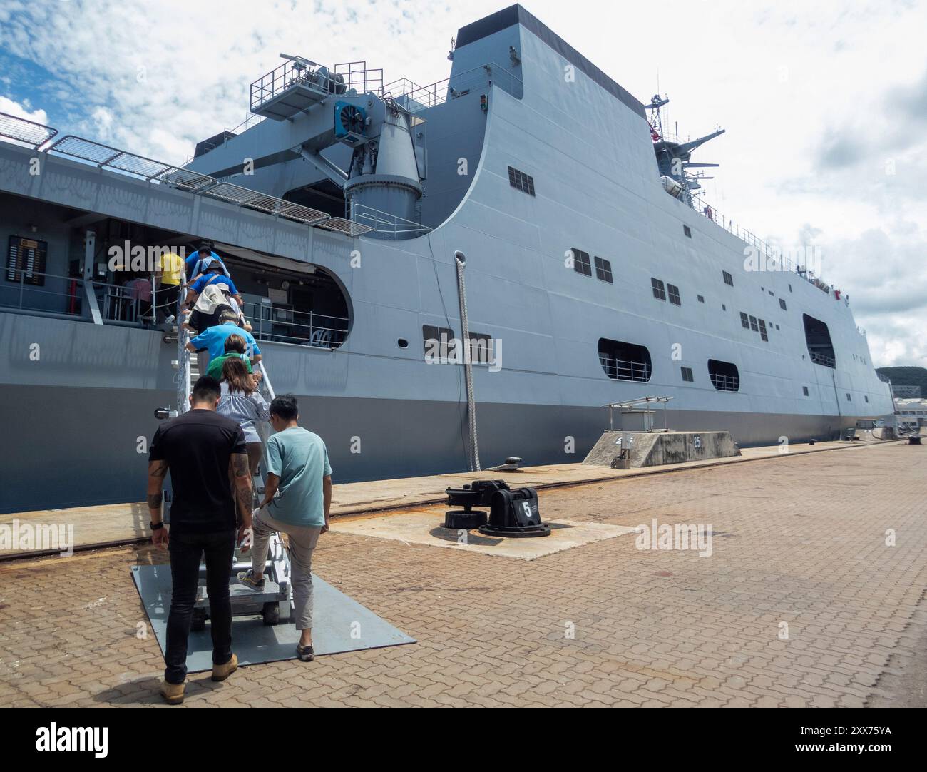 Visitors are seen boarding HTMS Chang (LPD-792) to tour the interior of ...