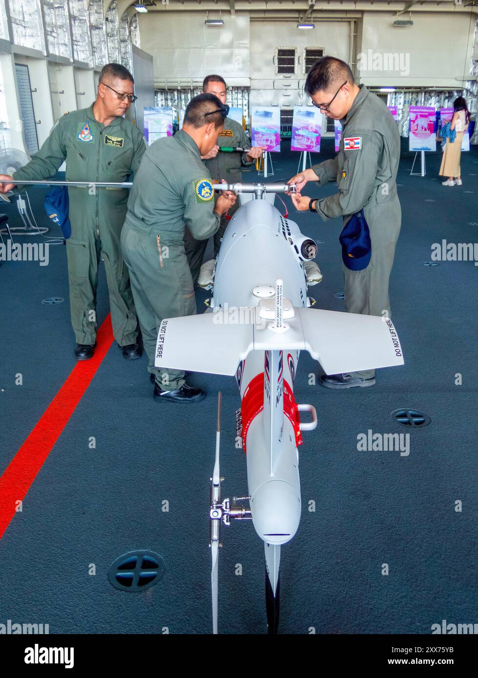 Thai Navy sailors are overseeing an unmanned aerial vehicle (UAV) being ...