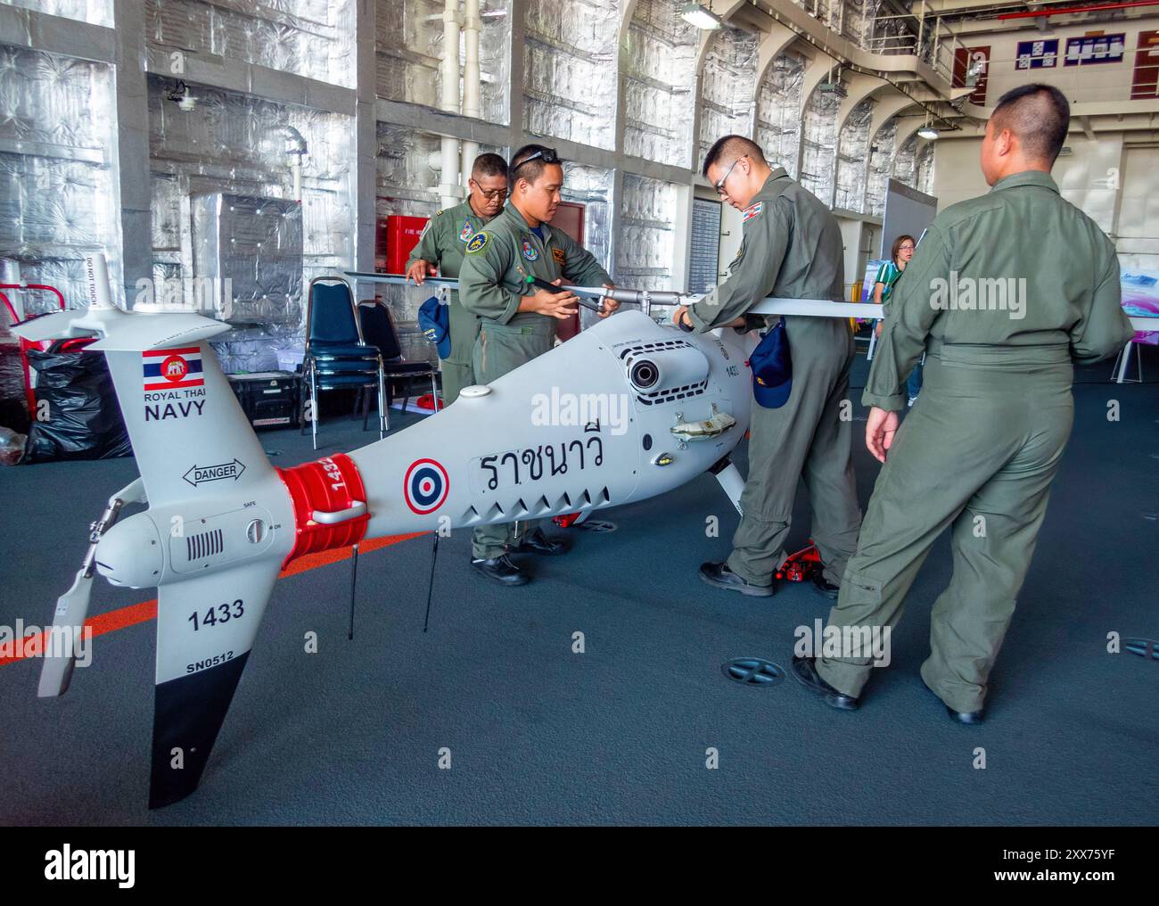 Thai Navy sailors are overseeing an unmanned aerial vehicle (UAV) being ...