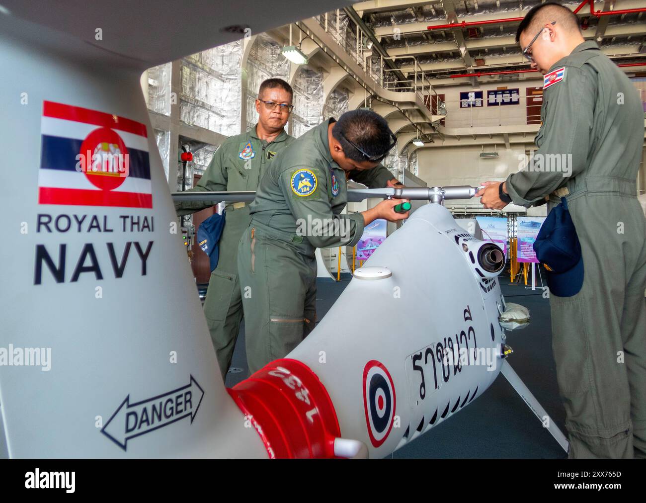Thai Navy sailors are overseeing an unmanned aerial vehicle (UAV) being ...