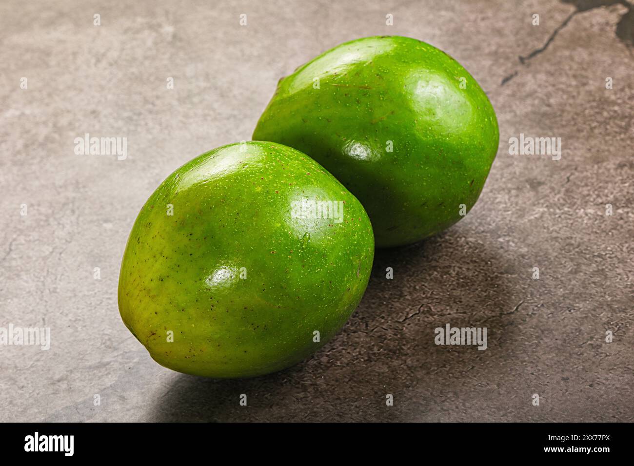 Two ripe green exotic avocado whole fruit Stock Photo - Alamy