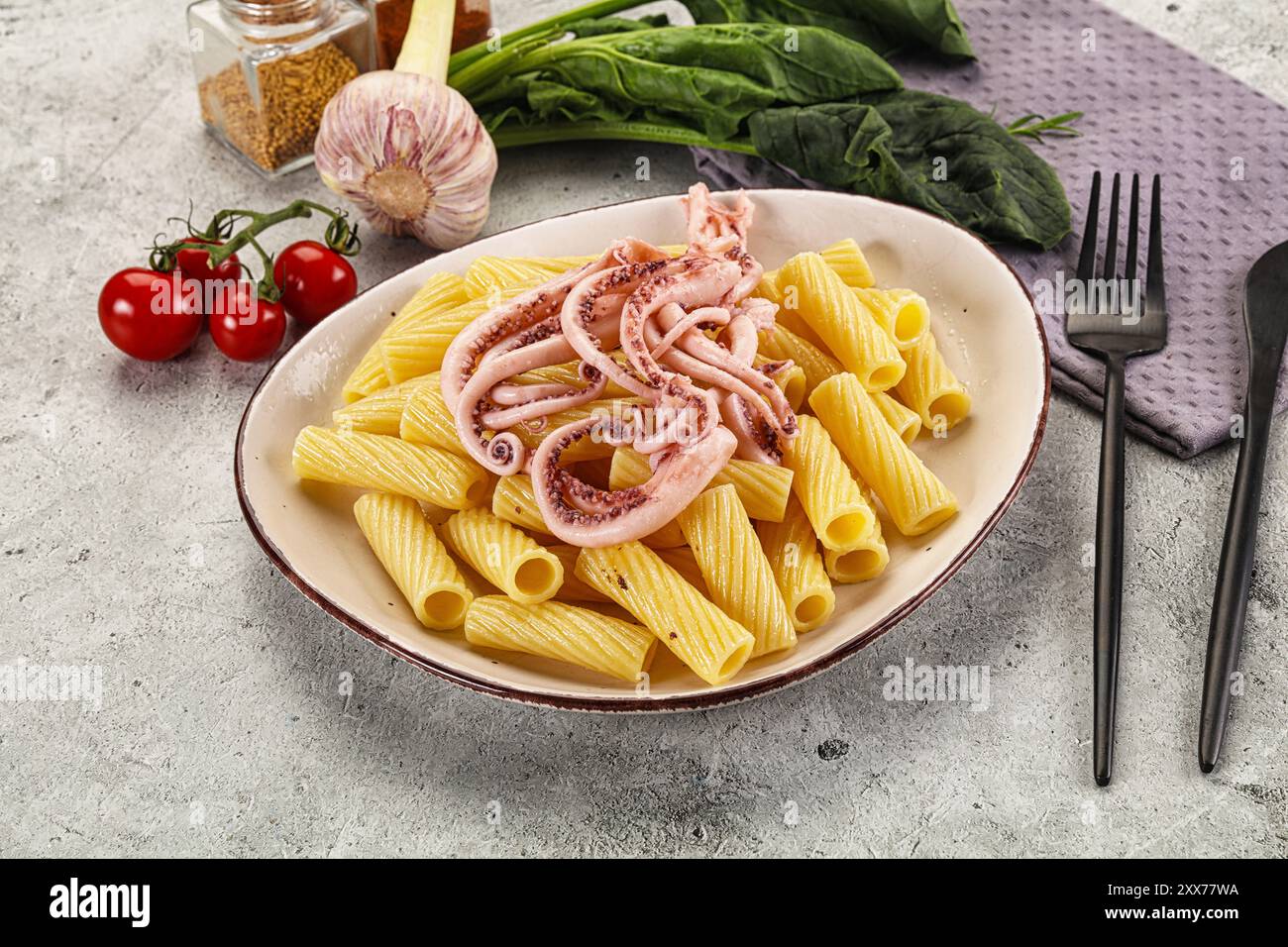 Italian cuisine - pasta tortiglioni with squid tentacles Stock Photo ...