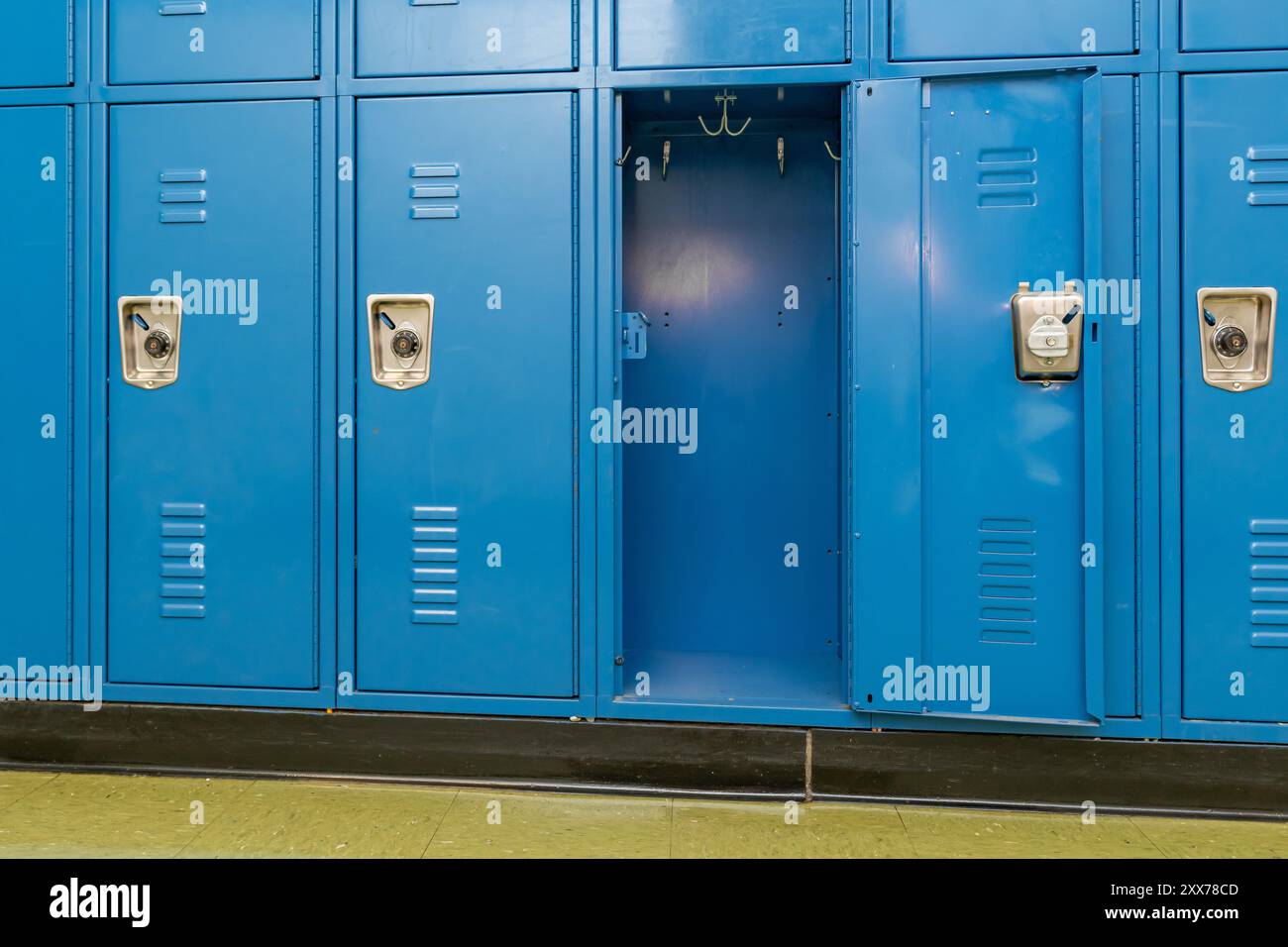 Single open empty blue metal locker along a nondescript hallway in a ...