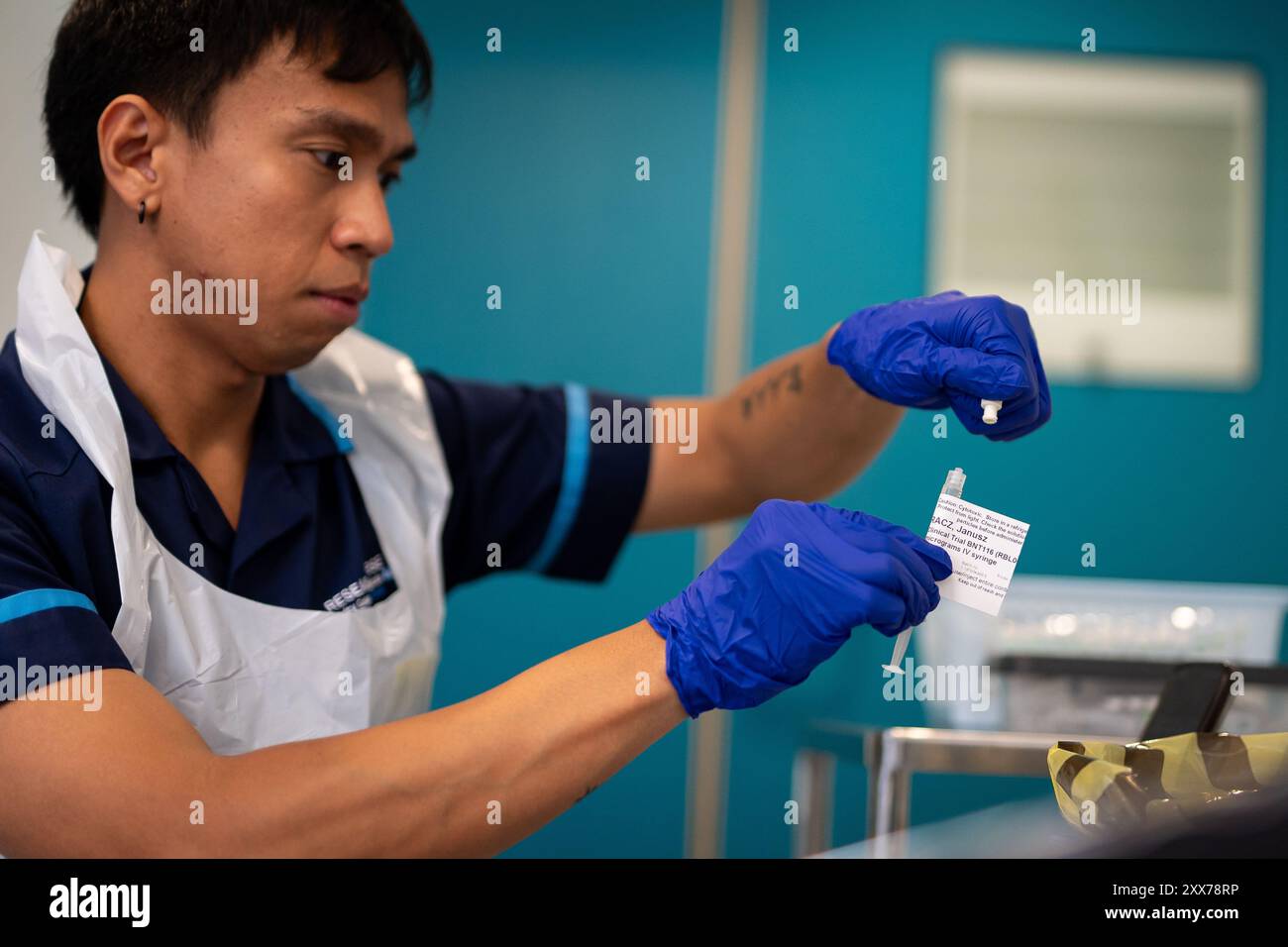 Keenjee Nama, senior research nurse holds an injection of a BioNTech ...