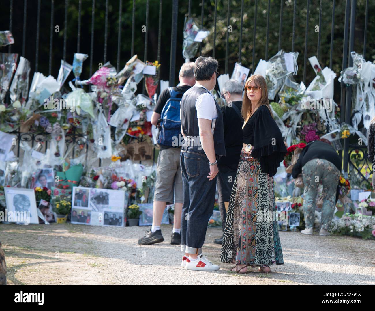 People pay tribute to late French actor Alain Delon as they put flowers ...