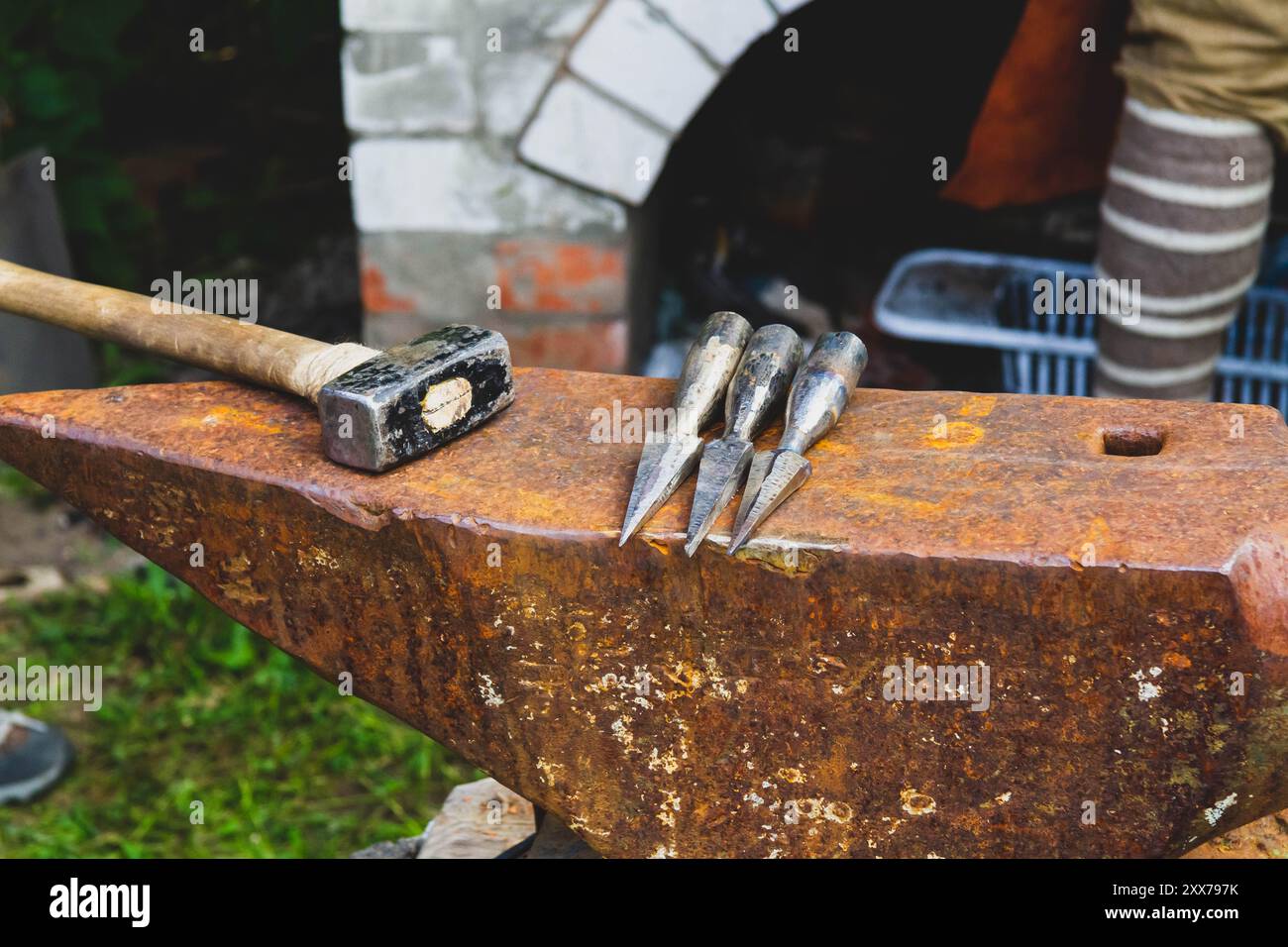 A blacksmith forges iron. Blacksmith's workshop. Blacksmith's anvil and ...