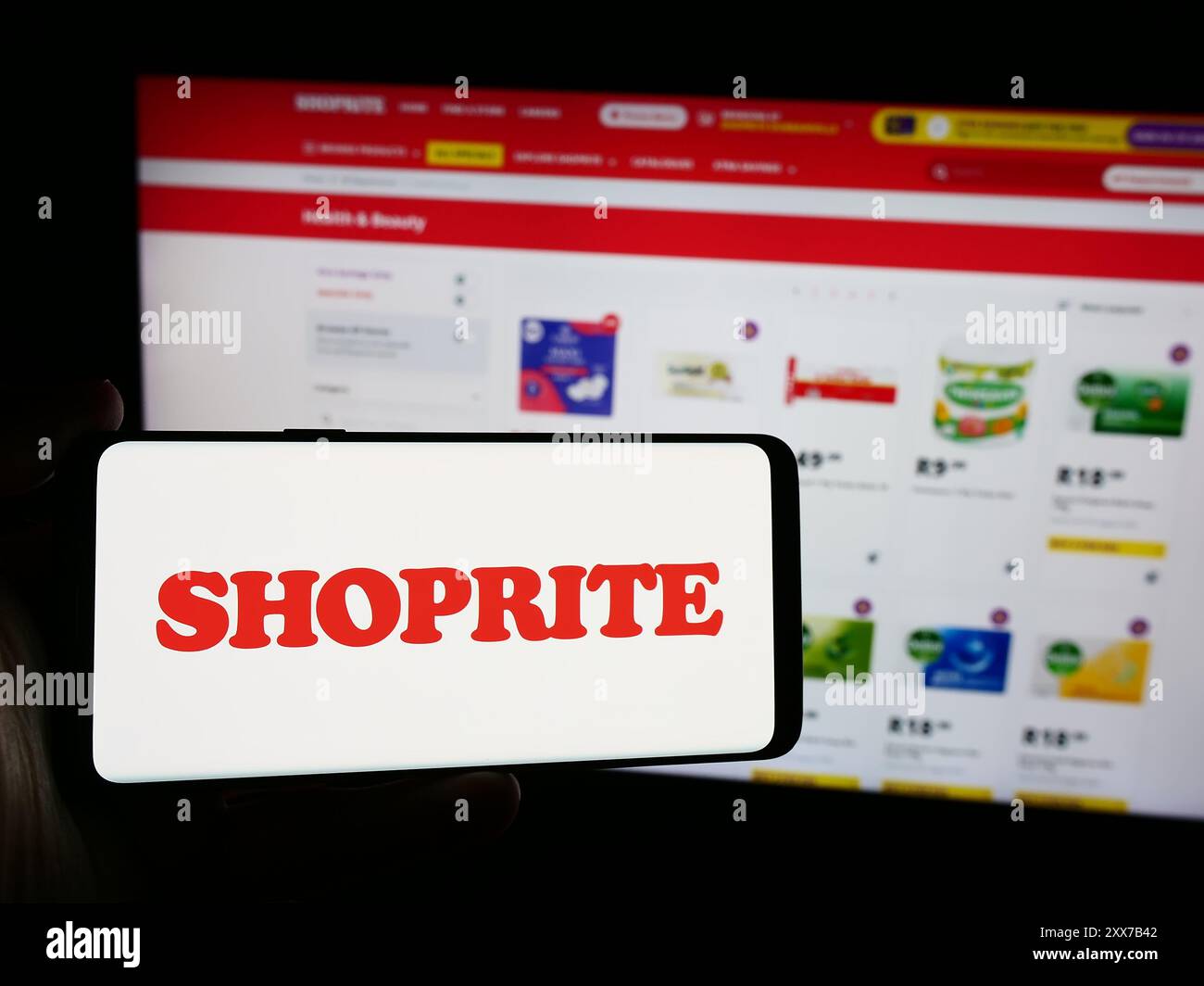 Person holding smartphone with logo of South African supermarket ...