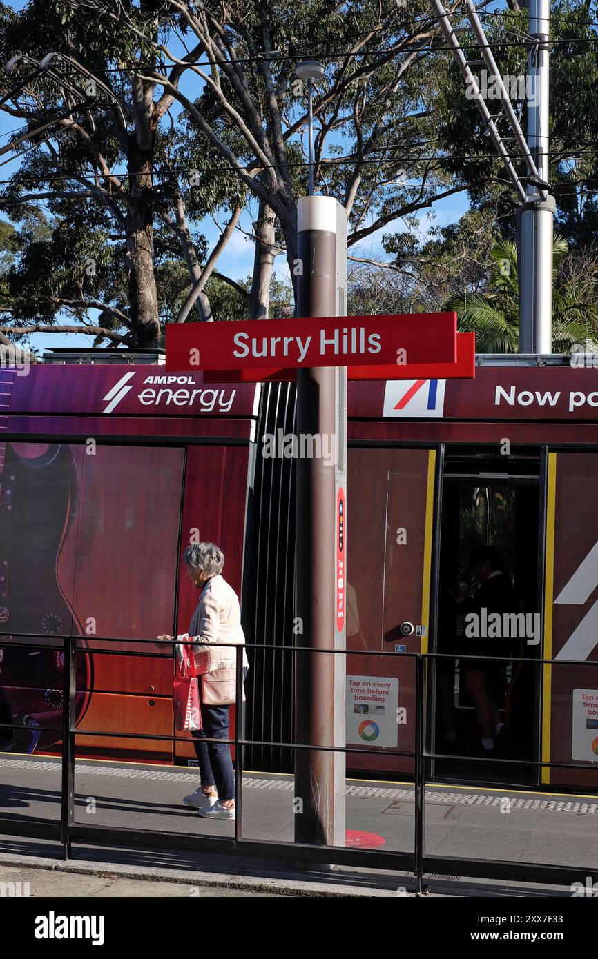 A woman on the platform as a passenger alights the tram at the Light ...