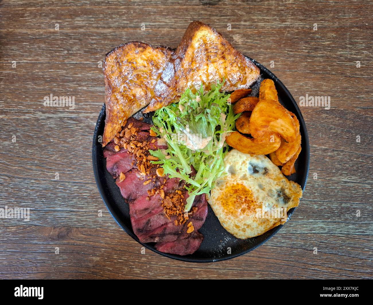 Brunch with red meat, egg, potato, bread and salad Stock Photo - Alamy