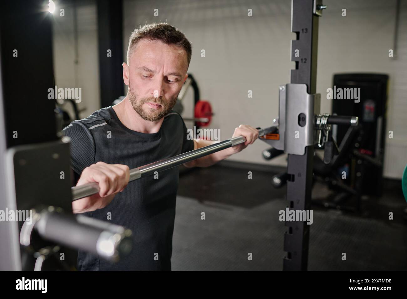 Highly skilled bodybuilder using Smith machine in gym Stock Photo - Alamy