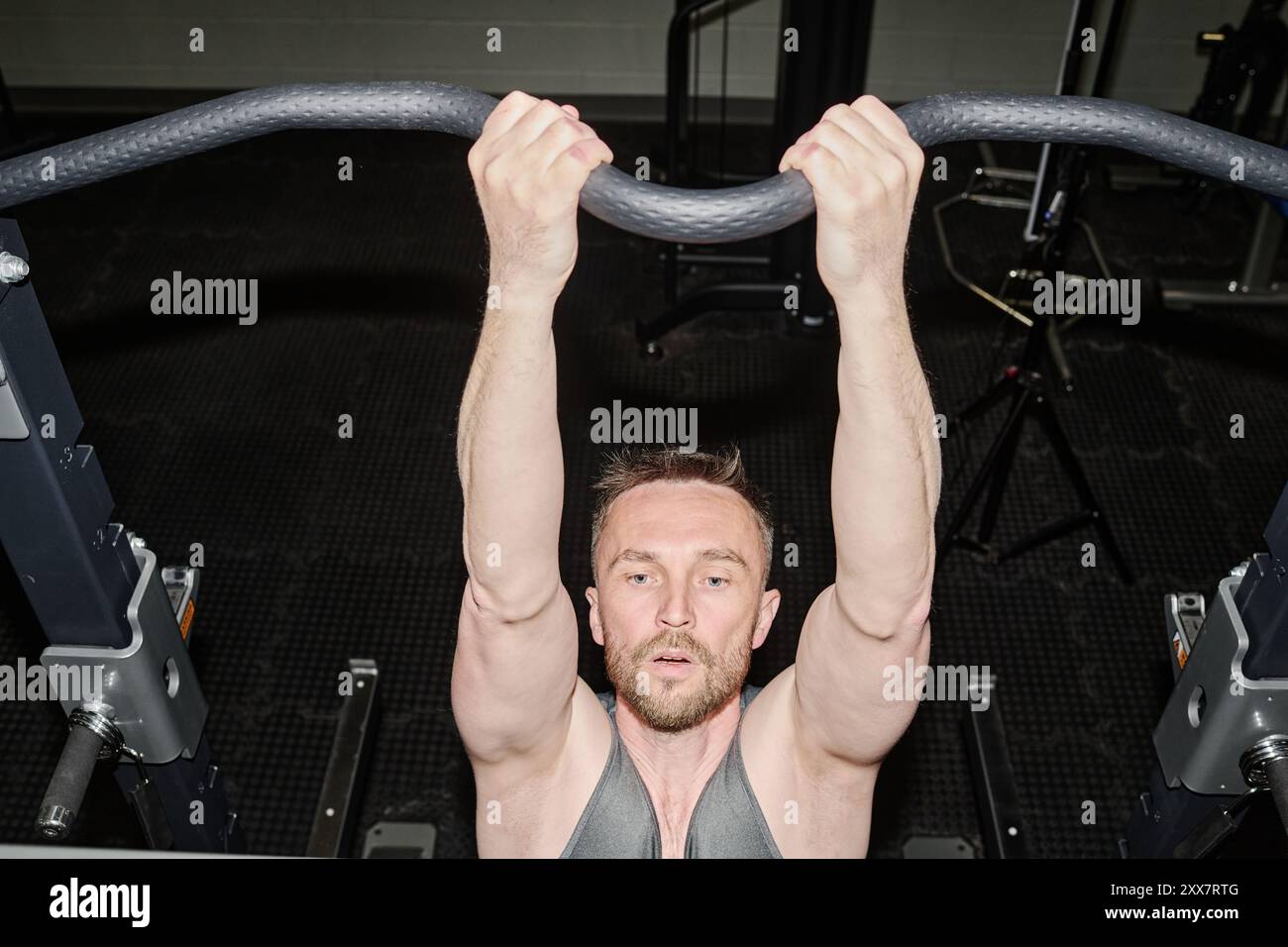 High angle shot of tired man doing pull-ups to develop muscles Stock ...