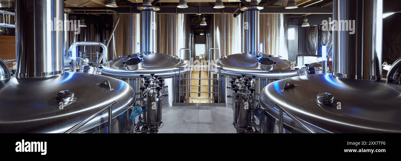 Gleaming stainless steel tanks and valves in the brewery highlight the ...