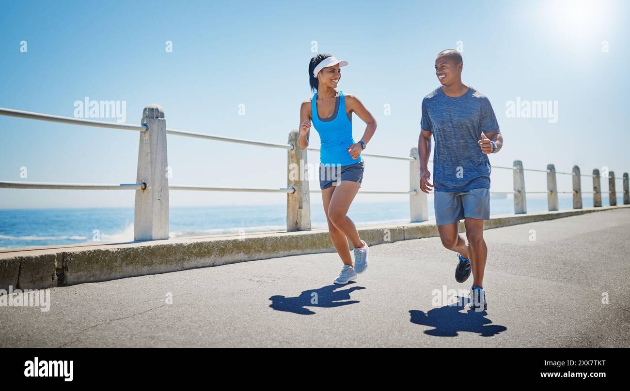 Happy, couple and running by ocean for fitness, physical health and ...