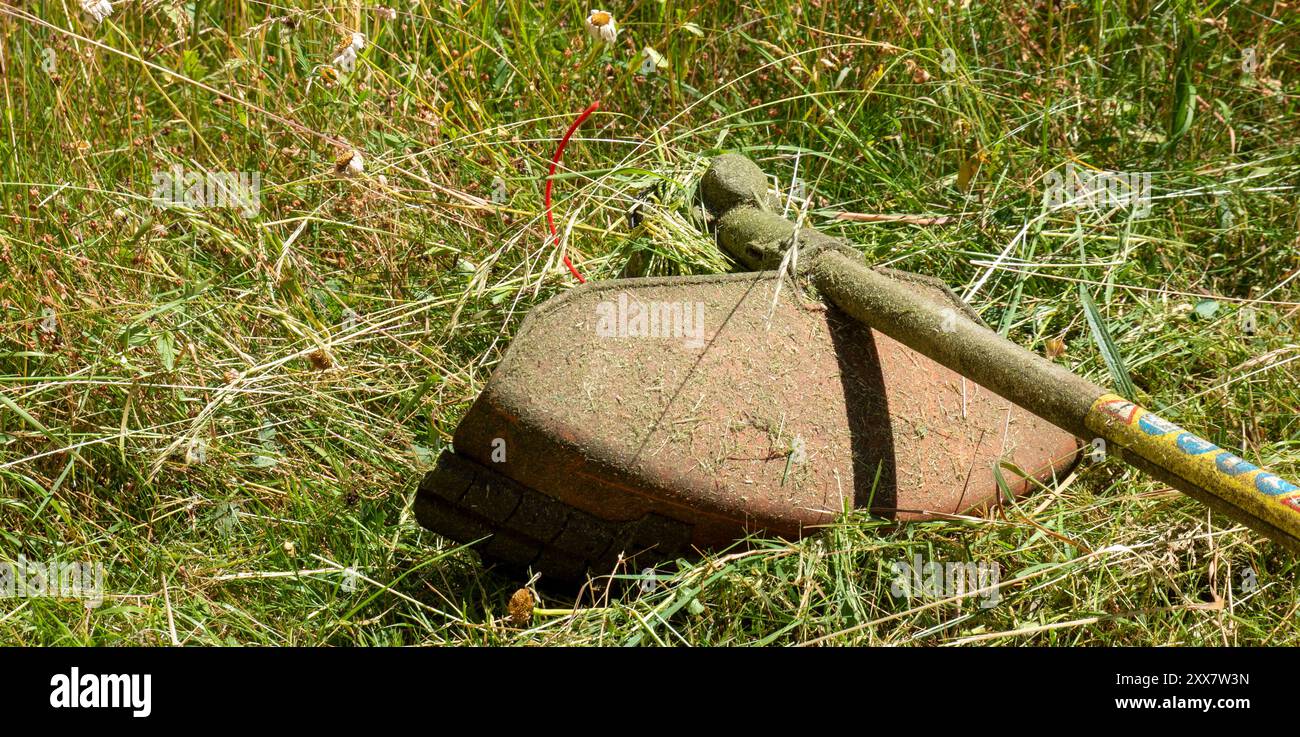 Brush cutter in a meadow mowing technology Stock Photo - Alamy