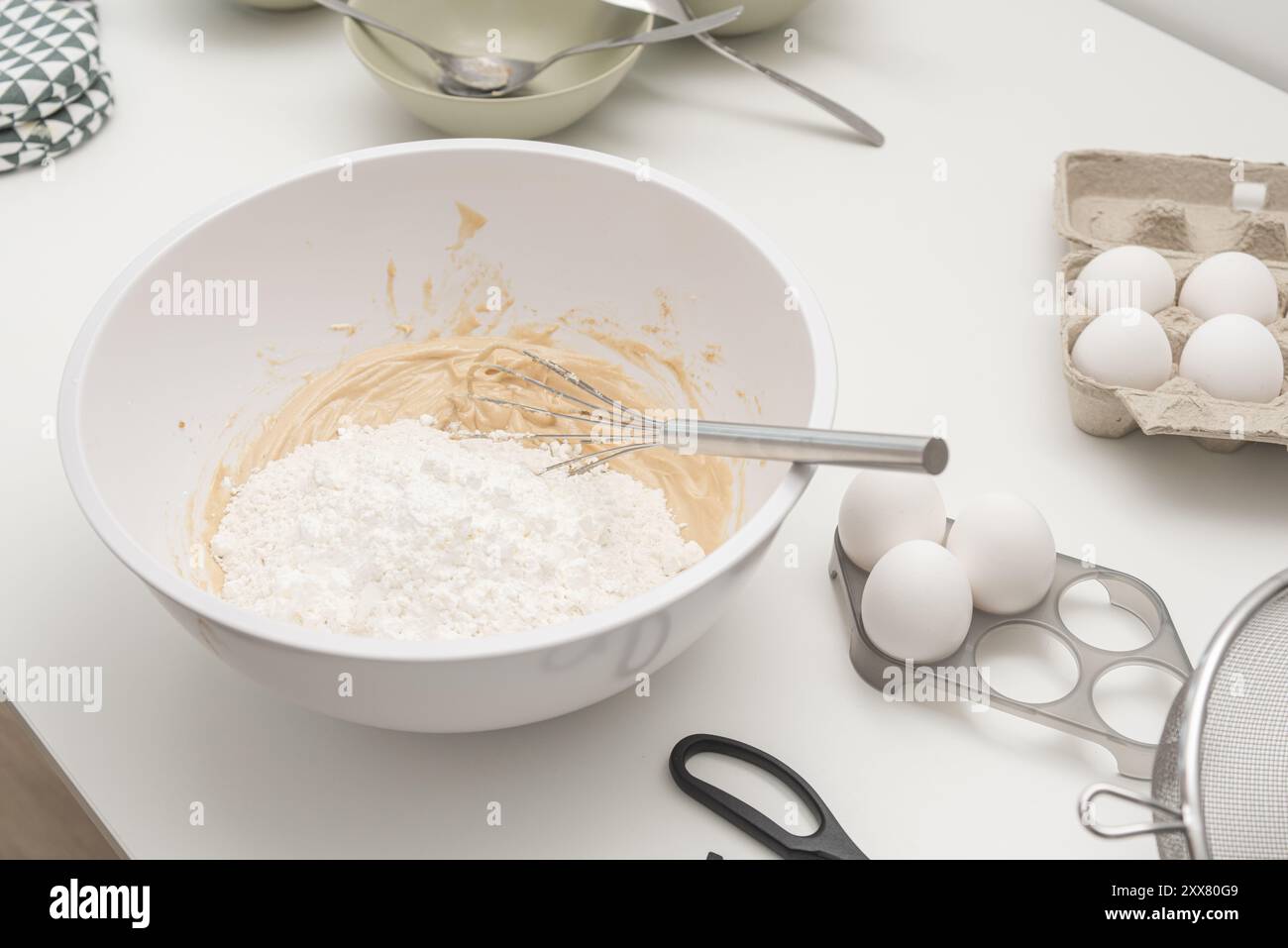 Mixing bowl with whisk blending flour to make a bakery recipe Stock ...