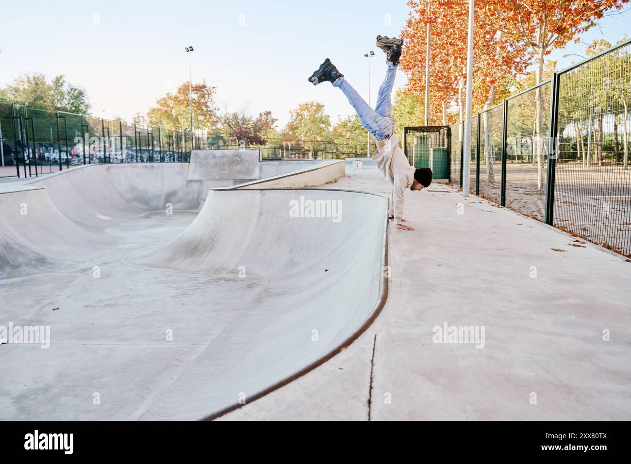 man doing acrobatics on top of a skatepark ramp Stock Photo - Alamy