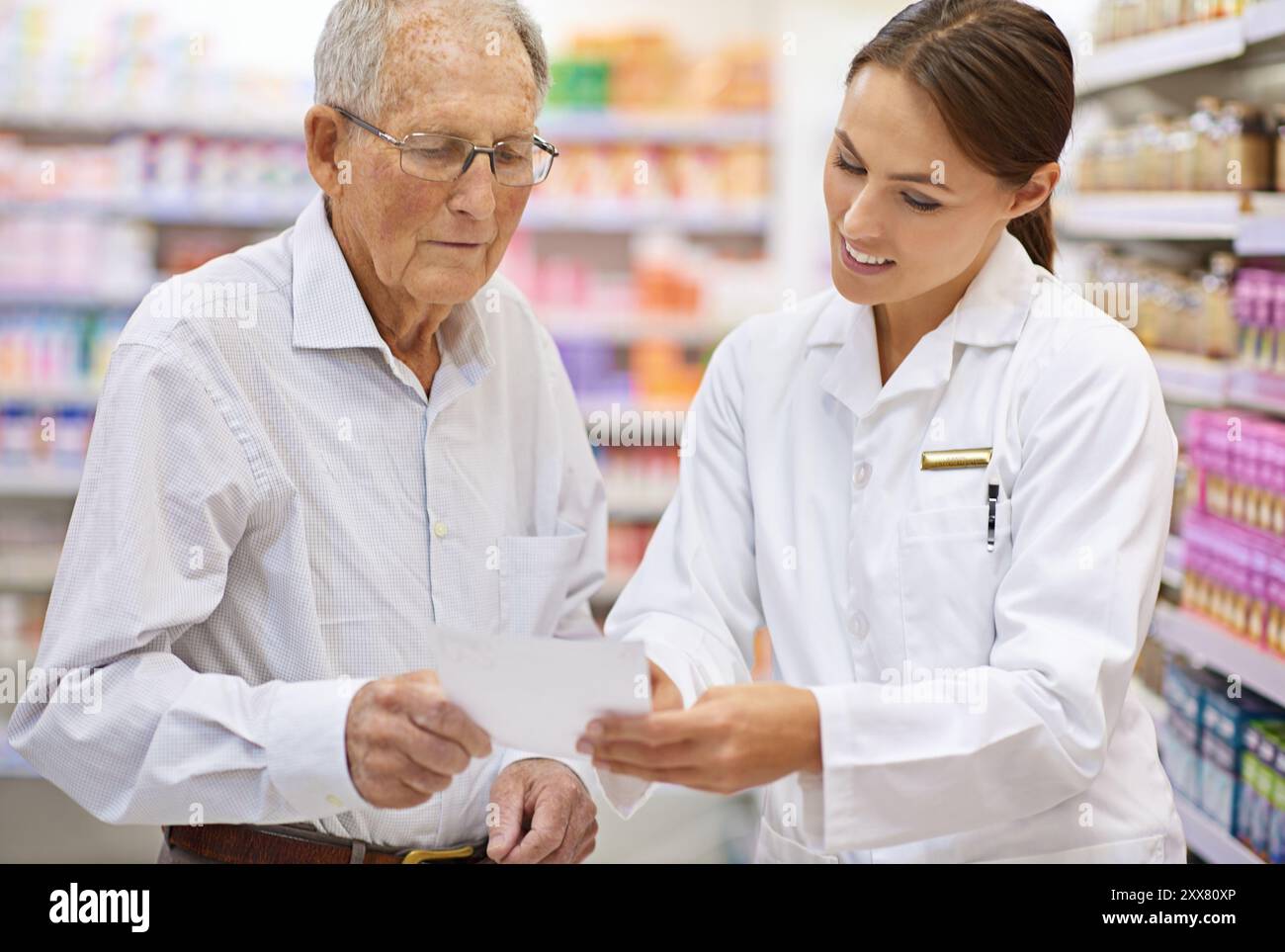 Ensuring her client is well informed. Shot of a young pharmacist ...